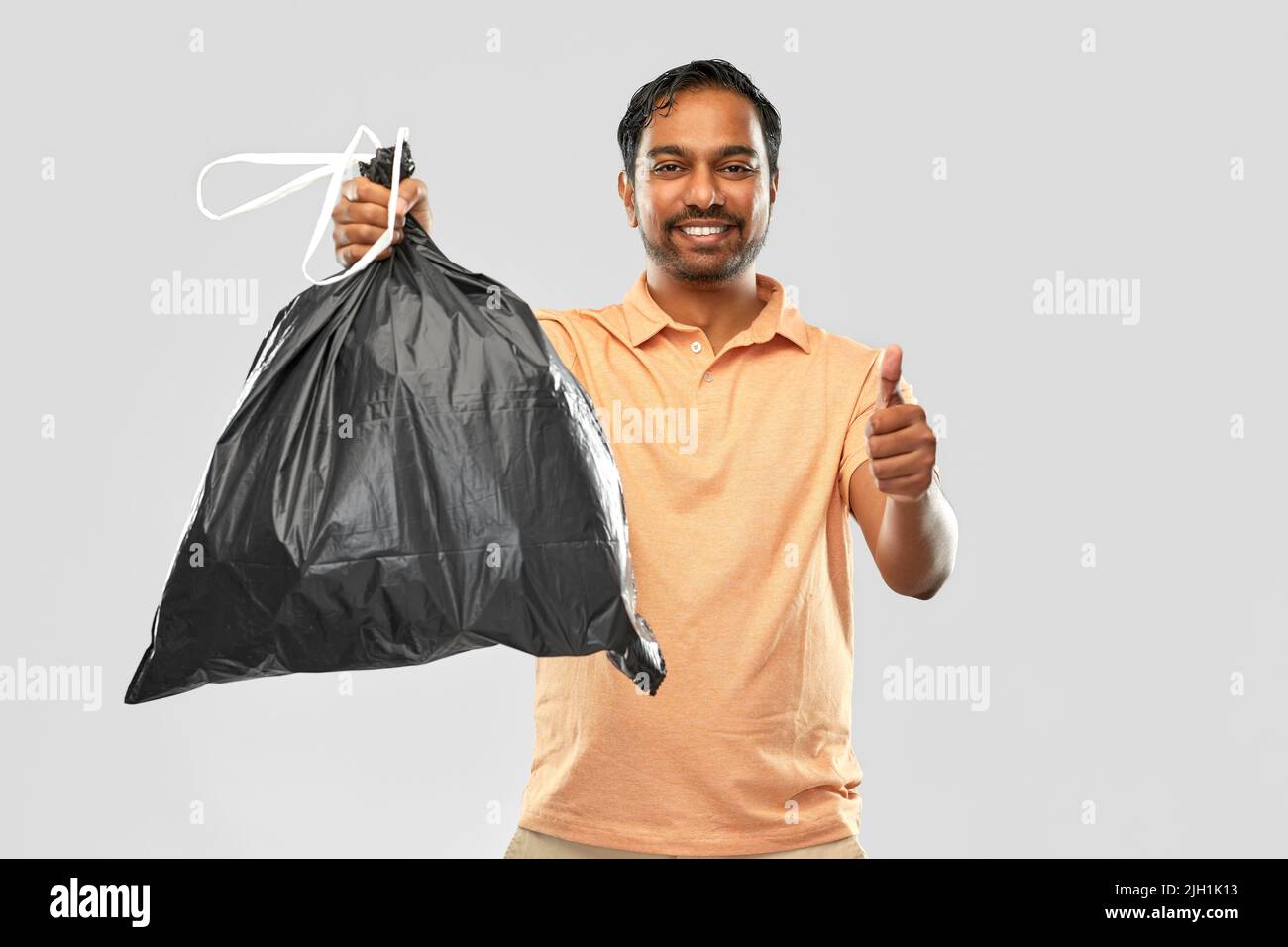 happy indian man with trash bag showing thumbs up Stock Photo - Alamy