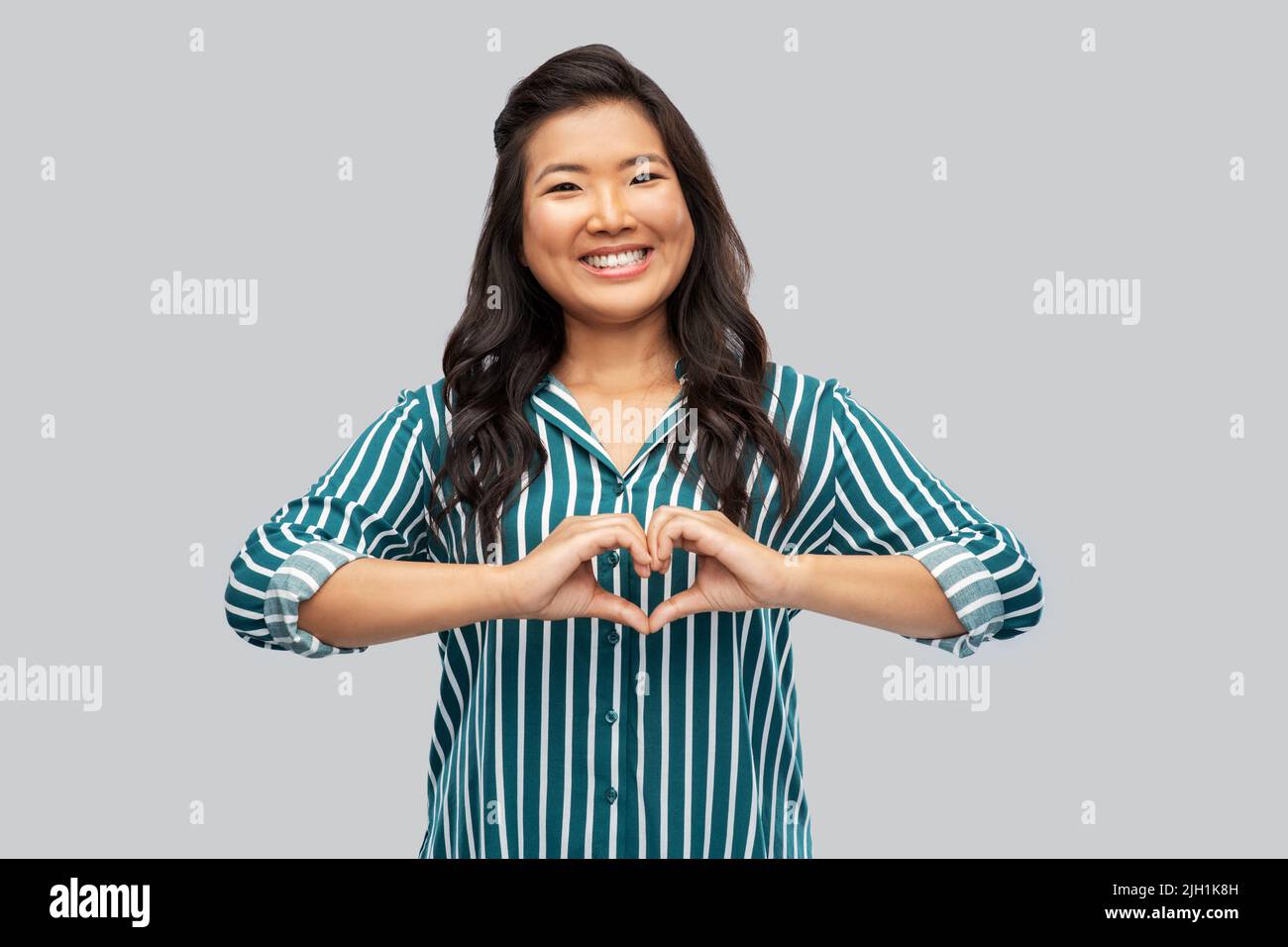 happy asian woman showing hand heart gesture Stock Photo - Alamy