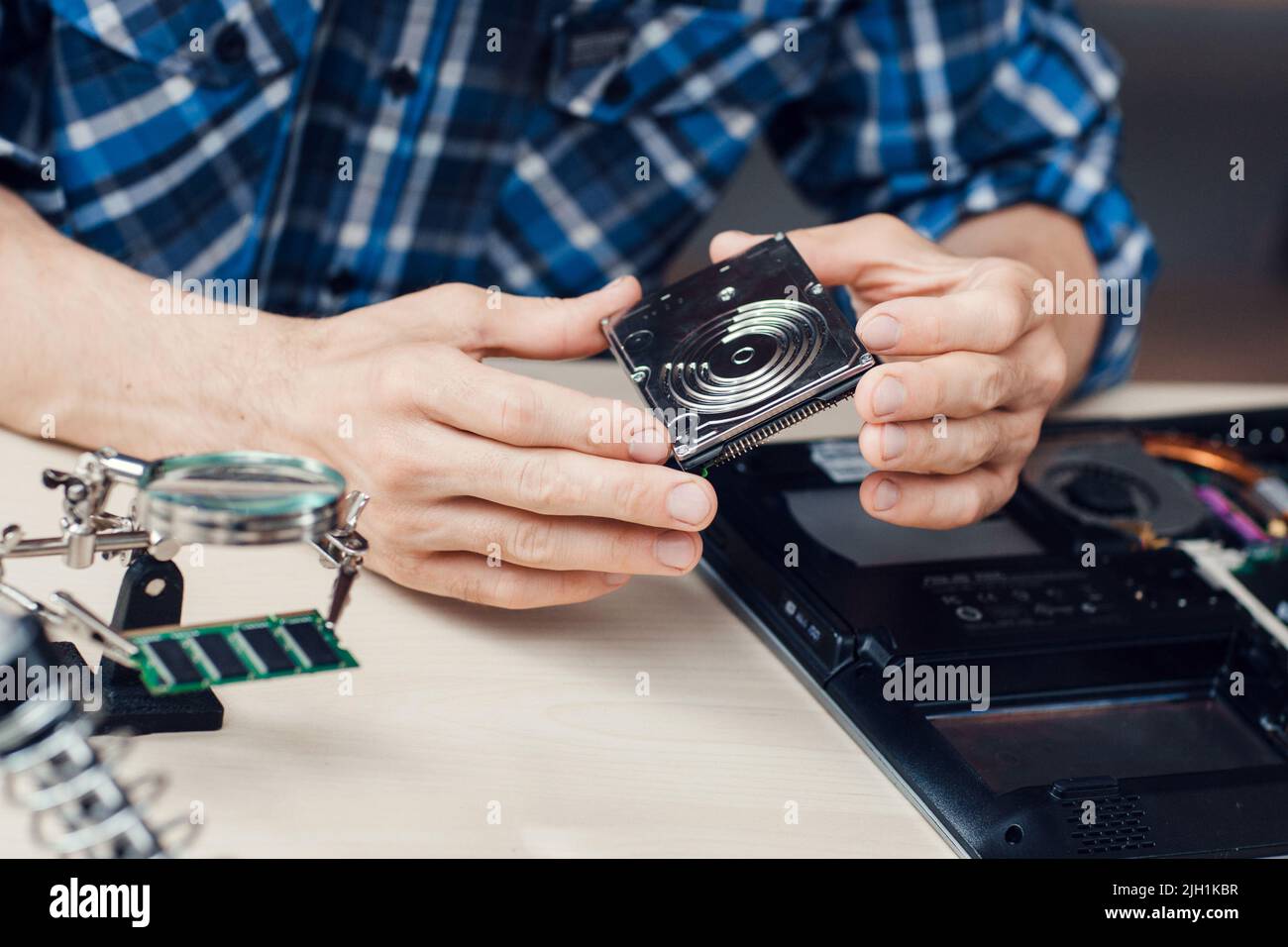 Engineer holding winchester disk in hands Stock Photo - Alamy
