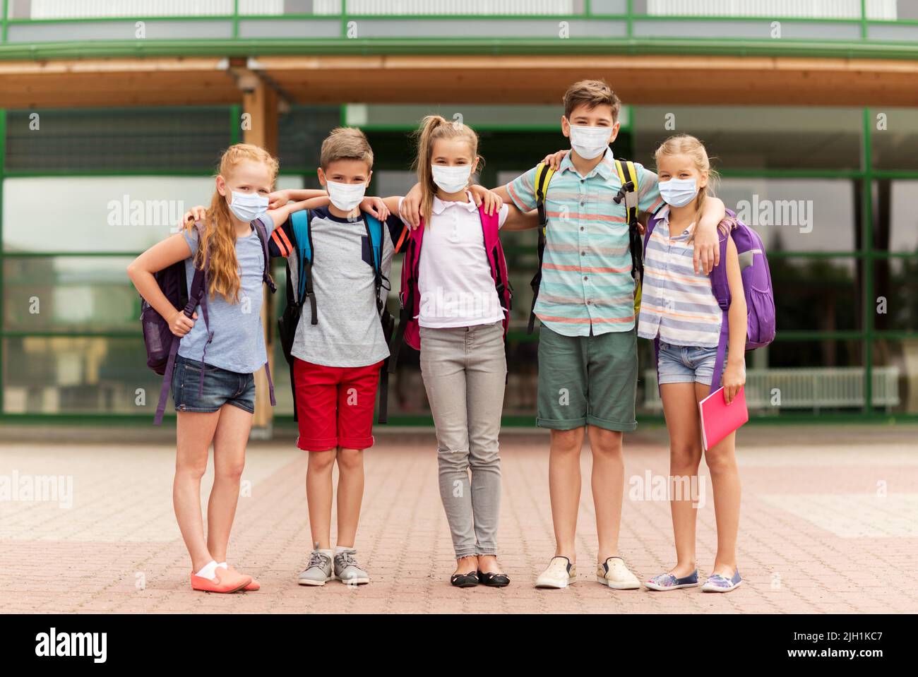 group of students in masks hugging over school Stock Photo - Alamy