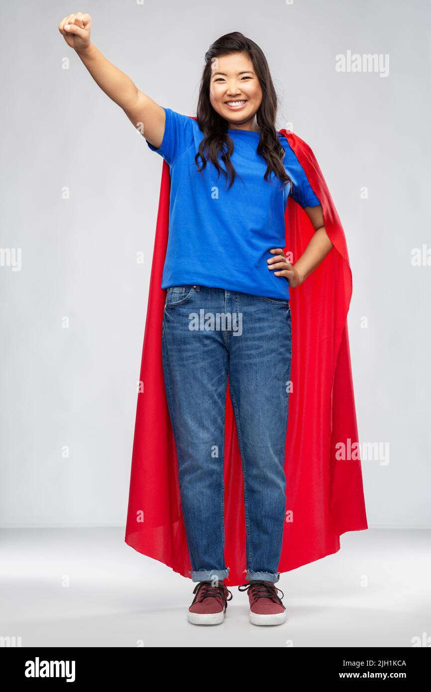 happy asian woman in red superhero cape Stock Photo - Alamy