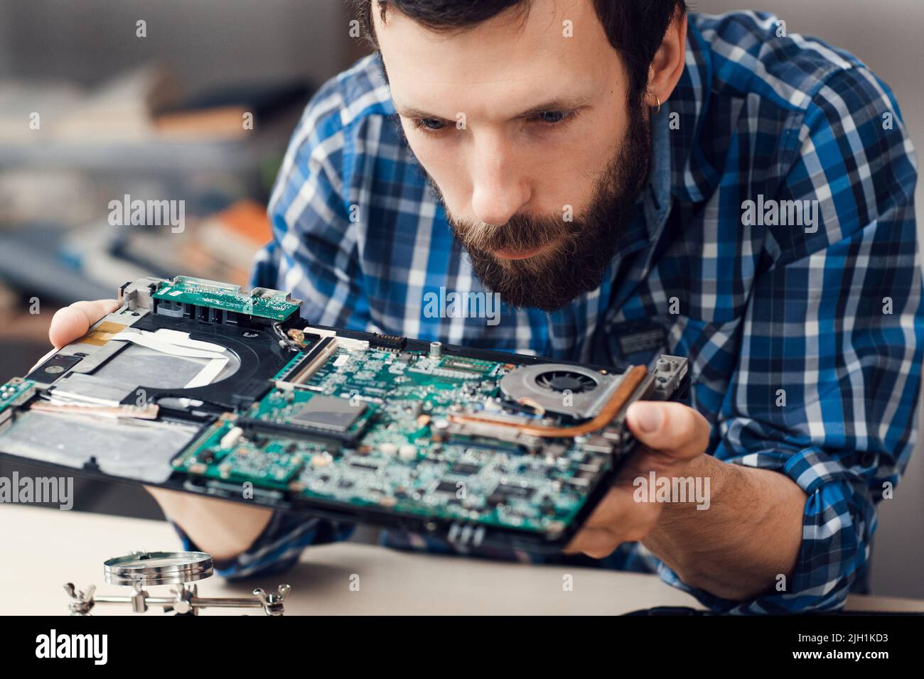 Engineer studying computer motherboard, close-up Stock Photo - Alamy