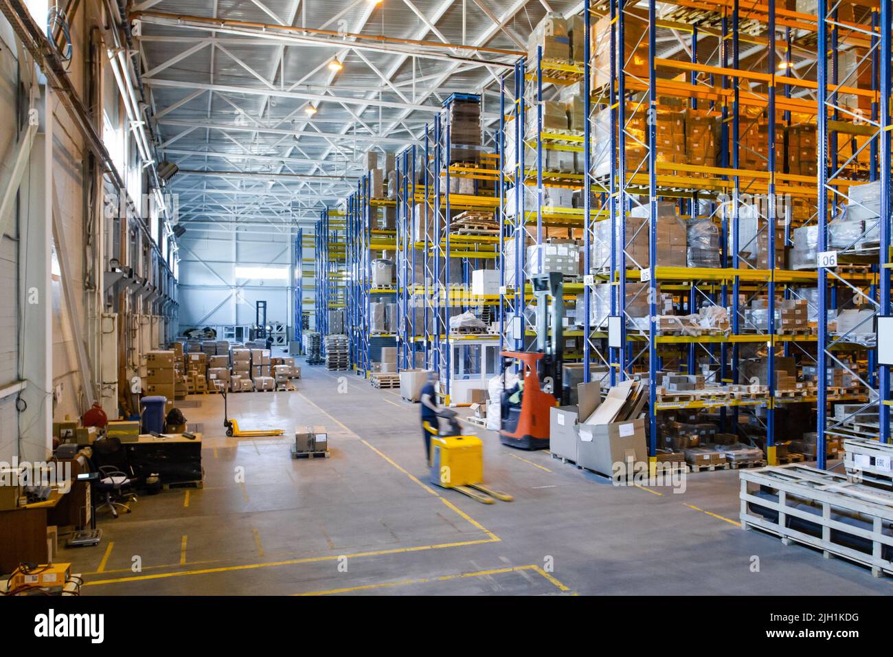 Interior of a modern warehouse storage of retail shop with pallet truck ...