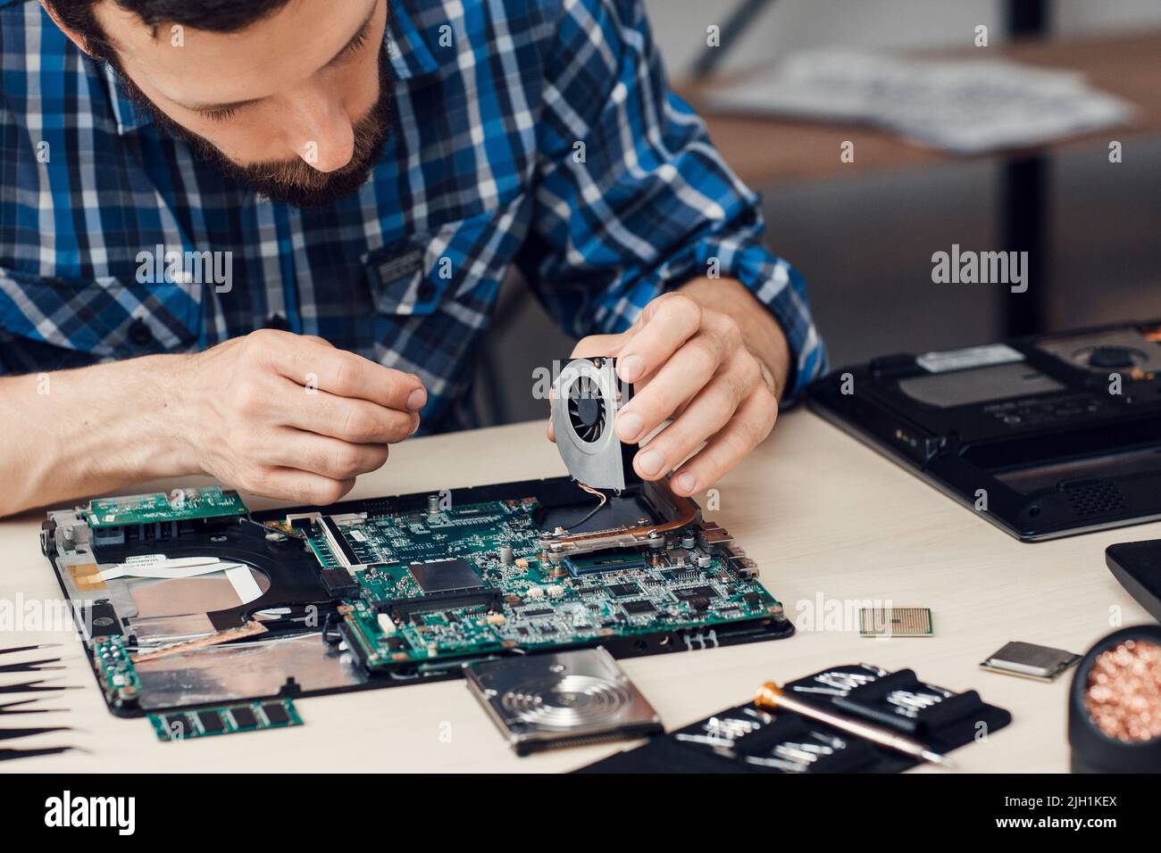 Repairman disassembling laptop motherboard Stock Photo - Alamy