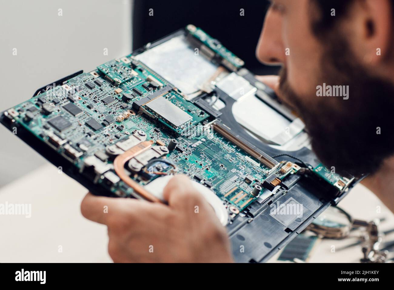 Engineer studying computer motherboard, close-up Stock Photo - Alamy