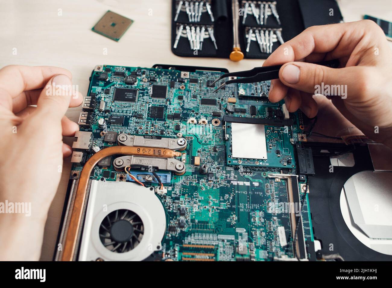 Laptop motherboard renovation at repair shop Stock Photo - Alamy