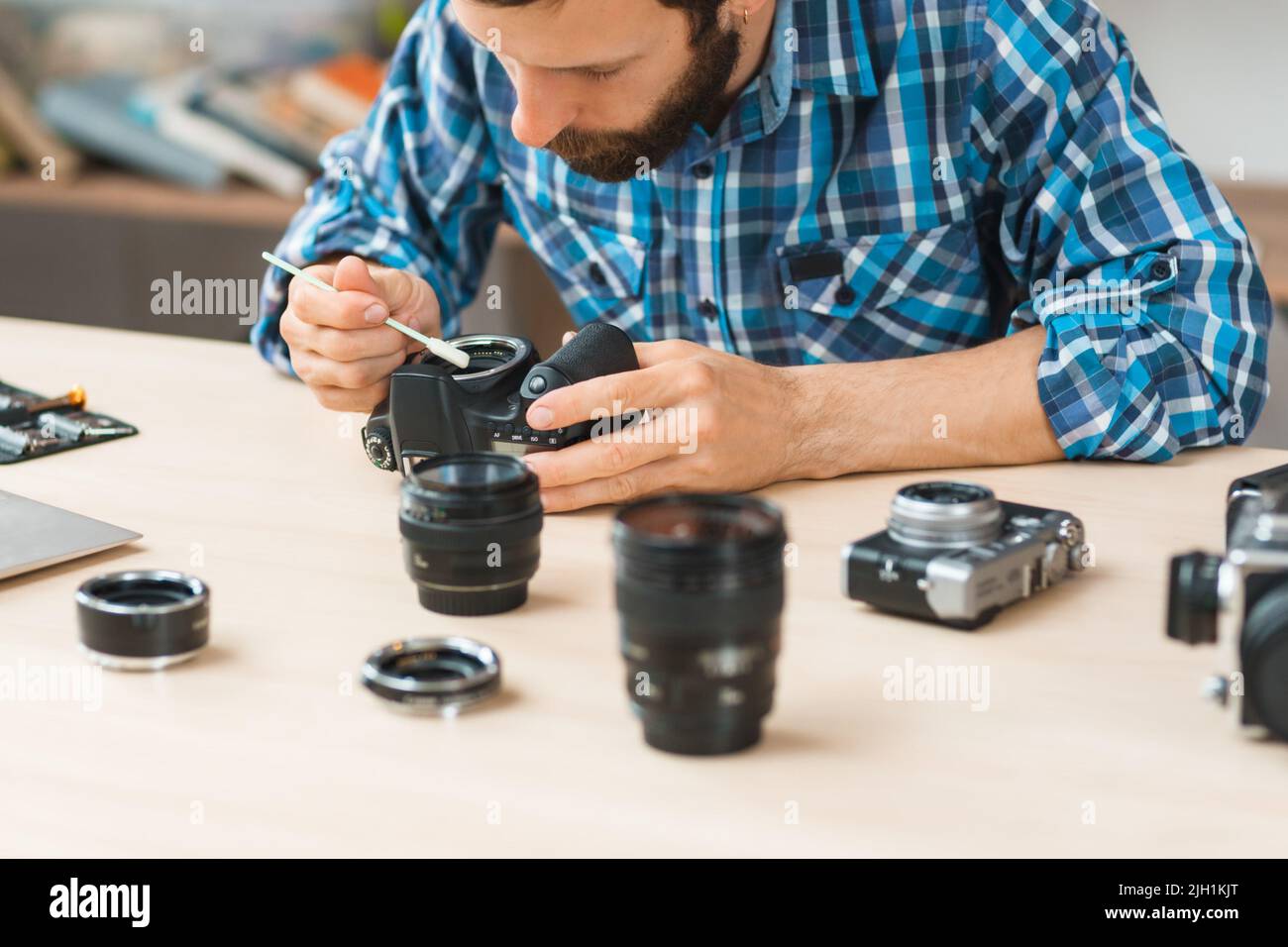 Maintenance of photo camera at workshop Stock Photo - Alamy