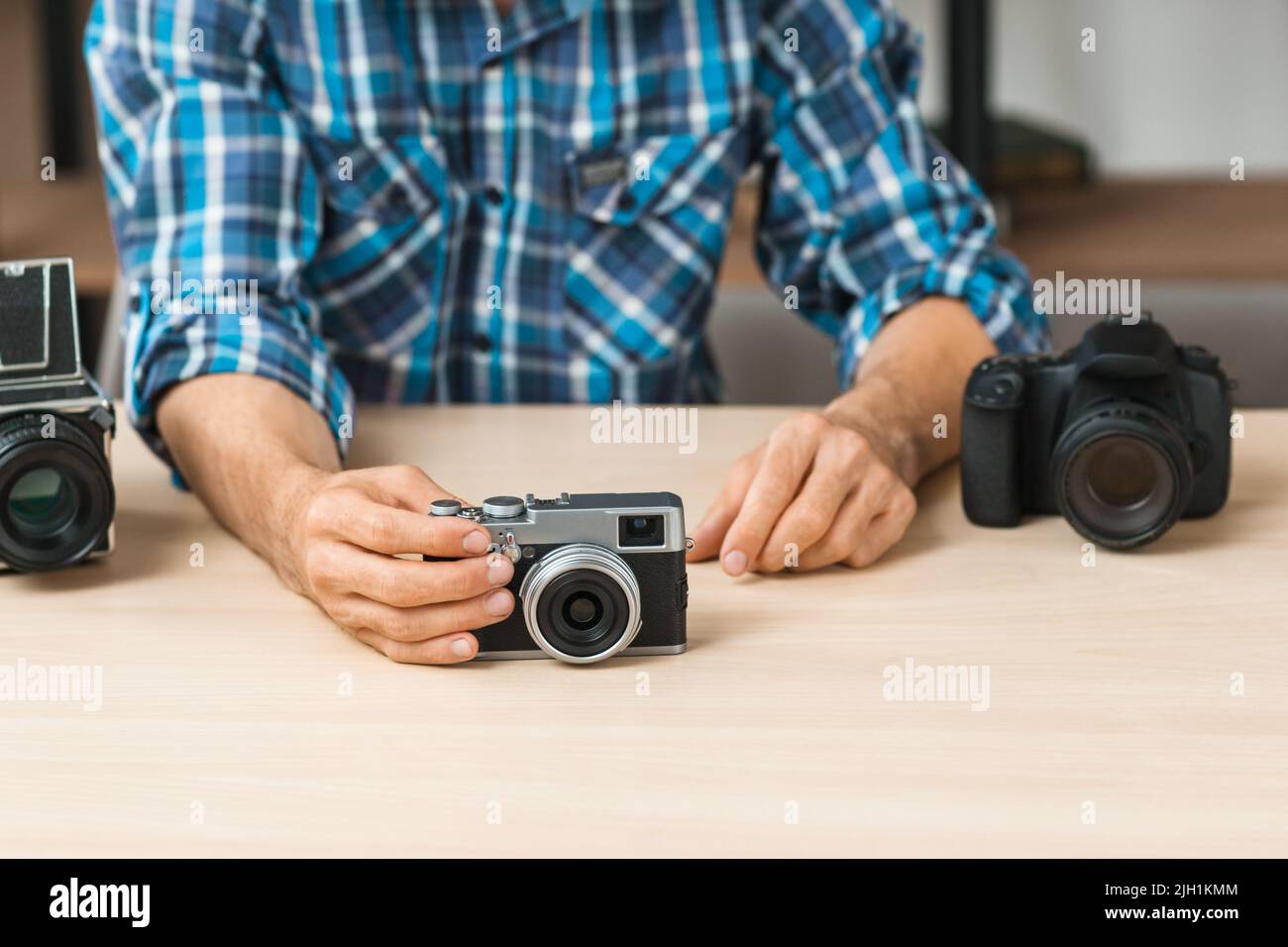 Simple film camera presentation on table Stock Photo - Alamy