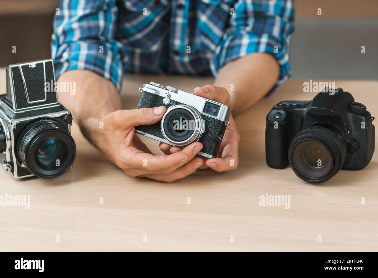 Unrecognizable man shows simple film camera Stock Photo - Alamy