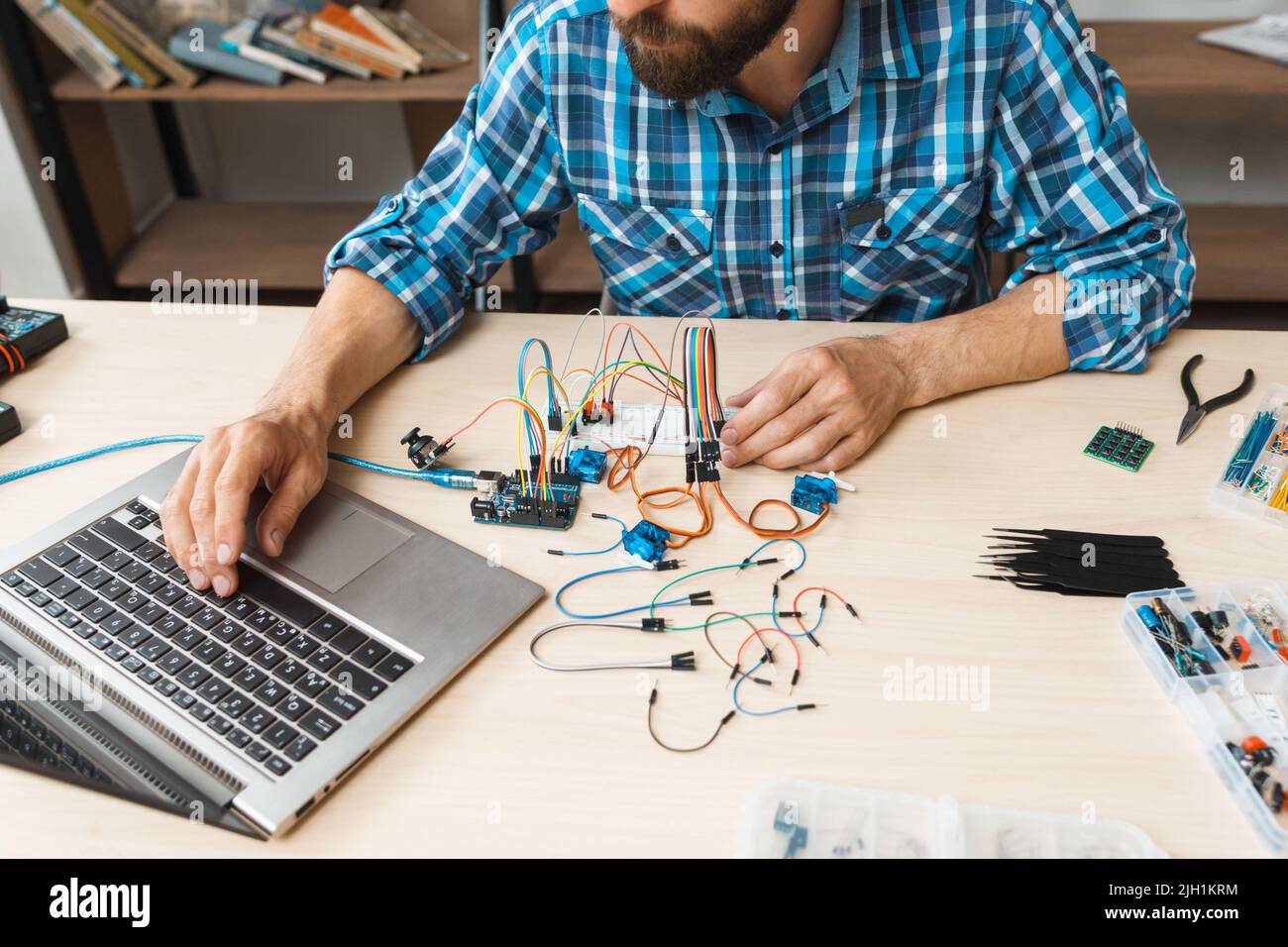 Programmer testing his new invention on laptop Stock Photo - Alamy