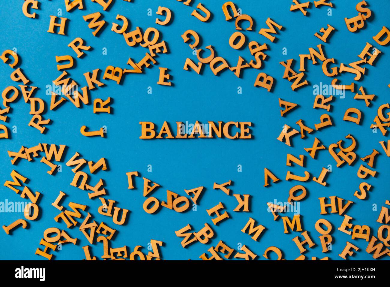Word BALANCE made out of wooden letters on bright blue background ...