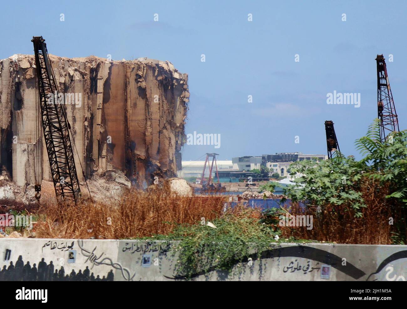 Smoke and fire come out from ravaged corn silos at the port of Beirut ...