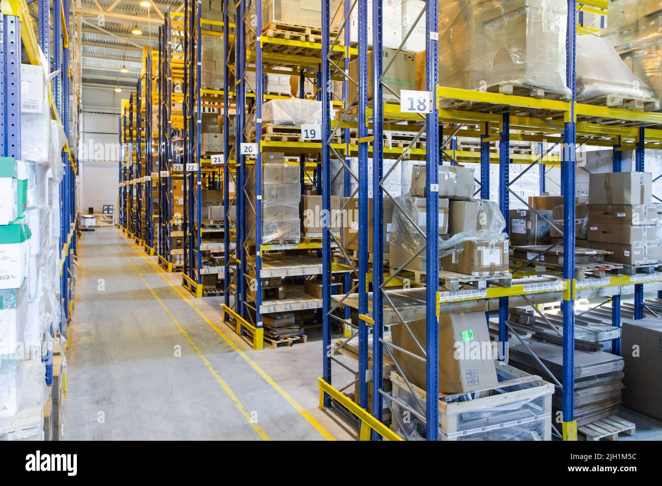 Interior of a modern warehouse storage with rows and goods boxes on ...