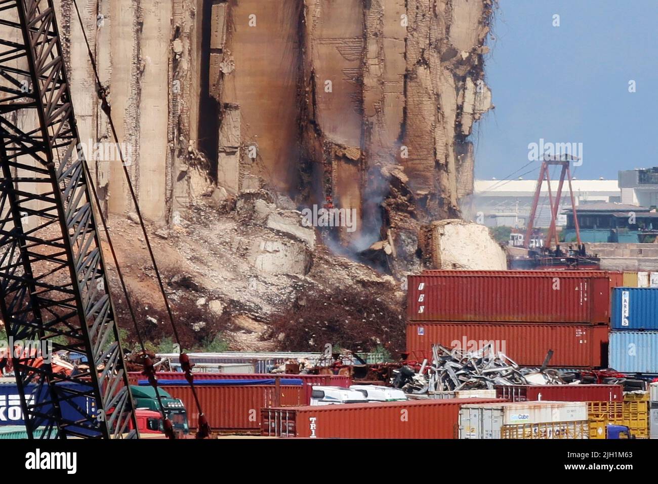 Smoke and fire come out from ravaged corn silos at the port of Beirut ...
