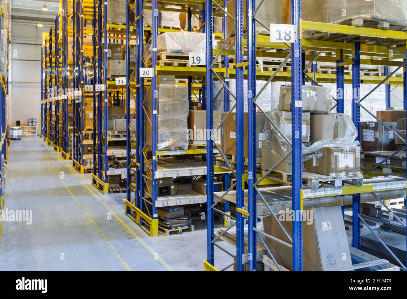 Interior of a modern warehouse storage with rows and goods boxes on ...