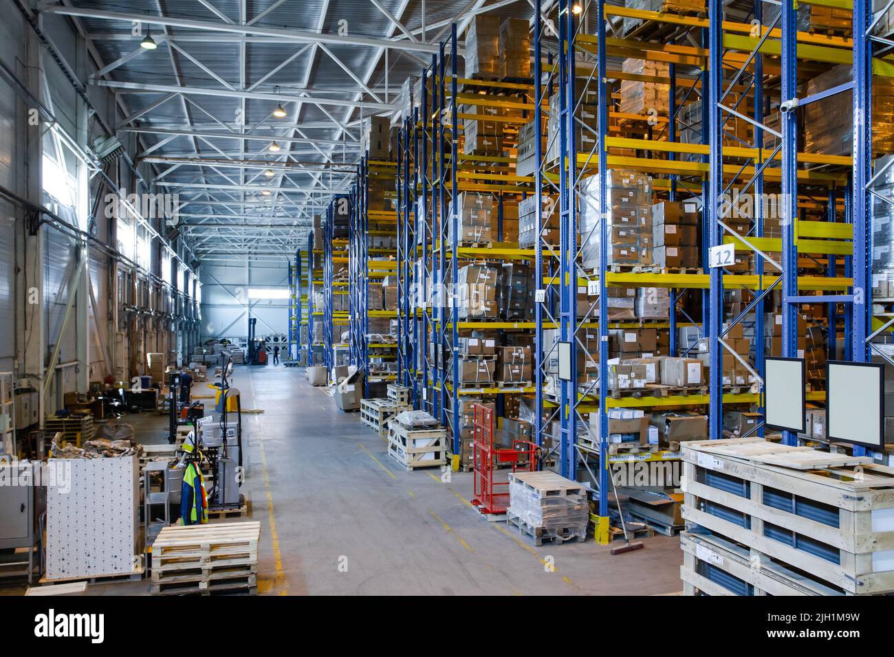 Interior of a modern warehouse storage of retail shop with pallet truck ...