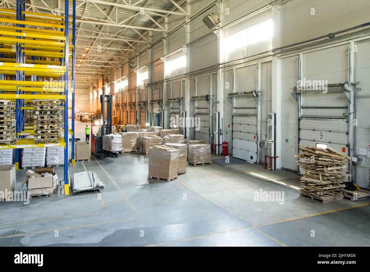 Interior of a modern warehouse storage of retail shop with pallet truck ...