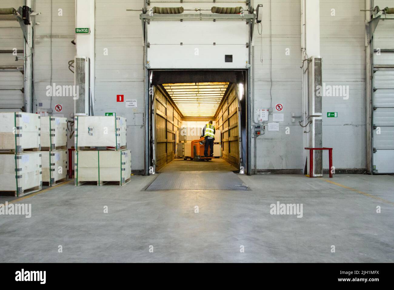 Interior of a modern warehouse storage of retail shop with pallet truck ...