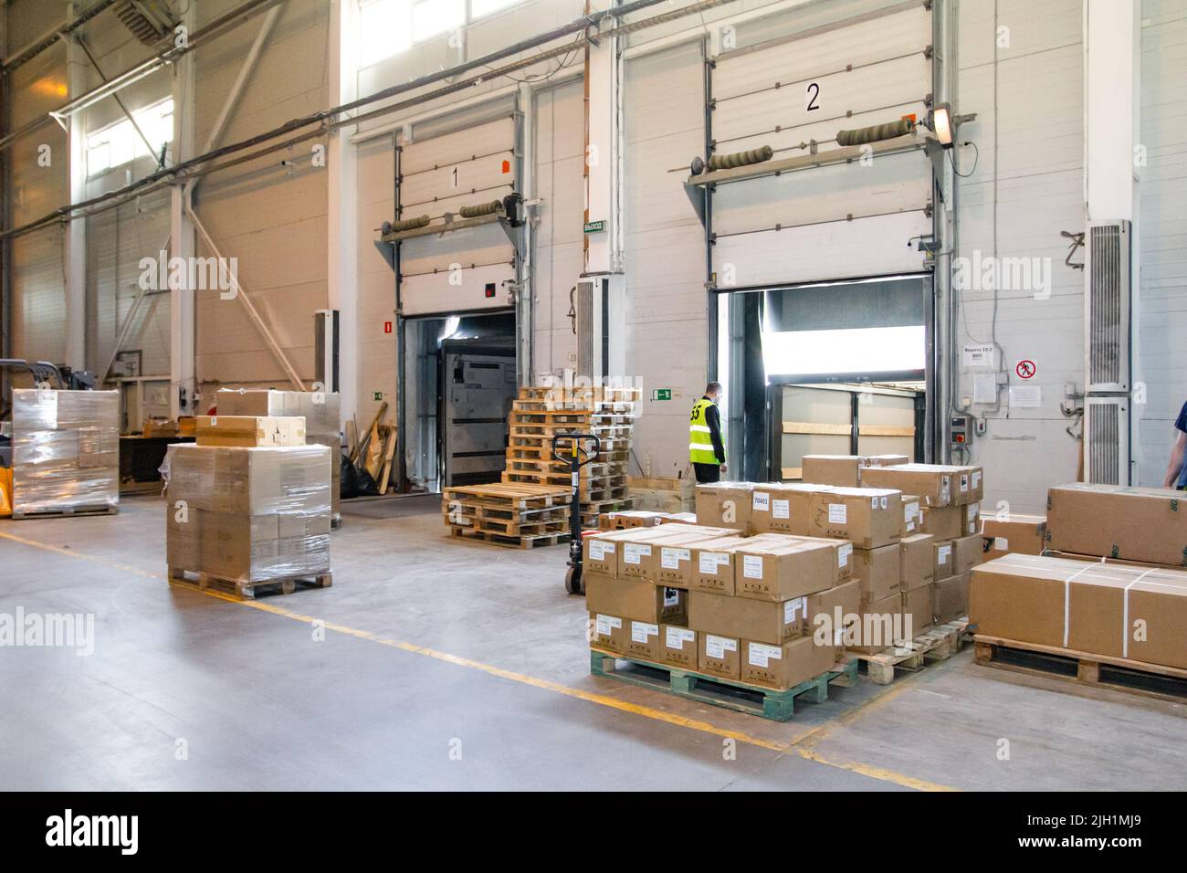 Interior of a modern warehouse storage of retail shop with pallet truck ...