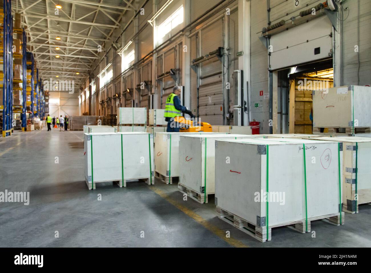 Interior of a modern warehouse storage of retail shop with pallet truck ...