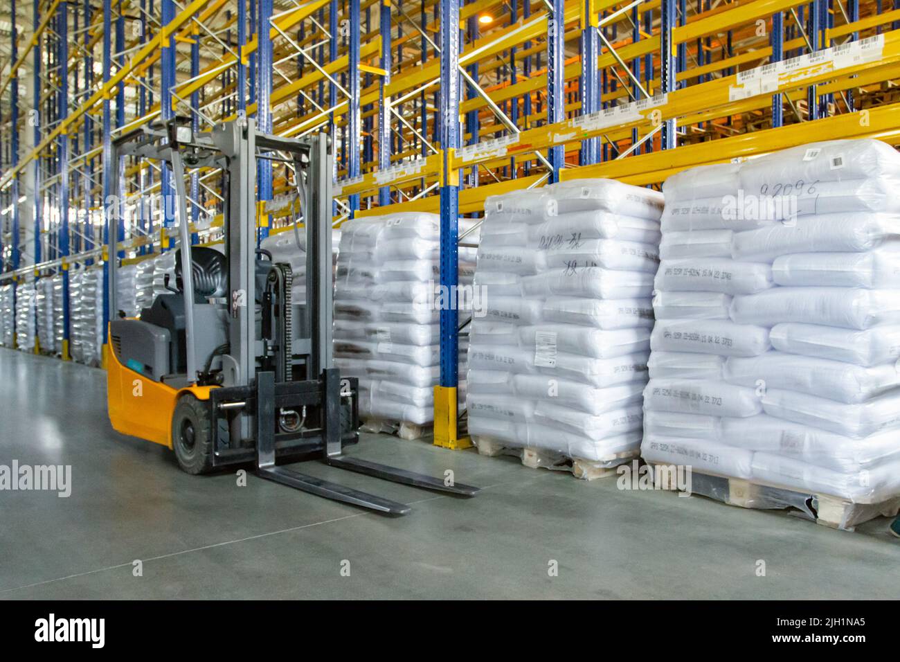 Interior of a modern warehouse with forklifts. Pallet stacker truck ...