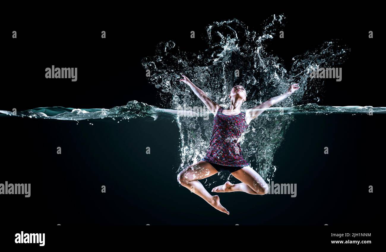 Professional woman swimmer on a wave Stock Photo - Alamy