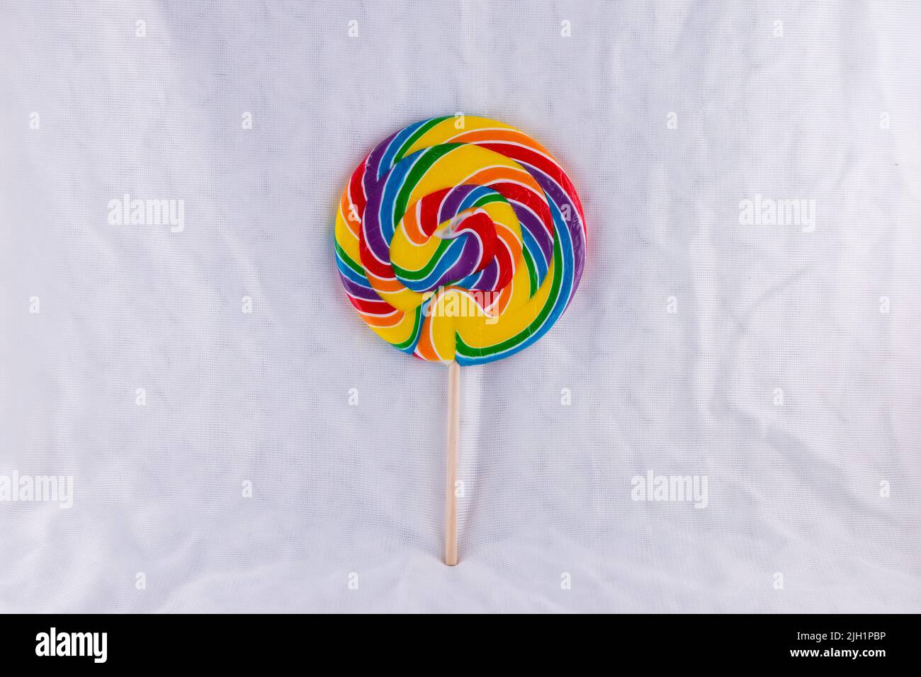 A top view of rainbow colored giant lollipop on white background Stock ...