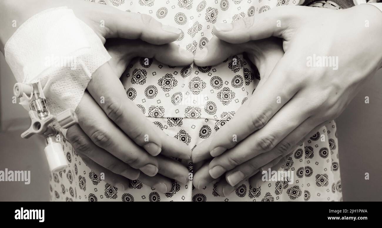 Cropped image of beautiful pregnant woman and her handsome husband ...