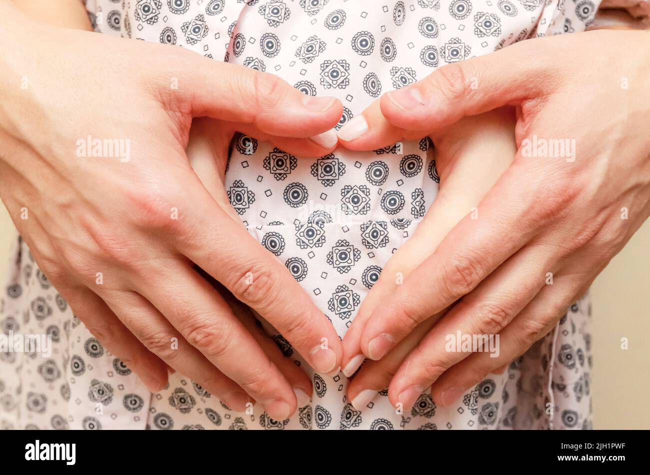 Cropped image of beautiful pregnant woman and her handsome husband ...