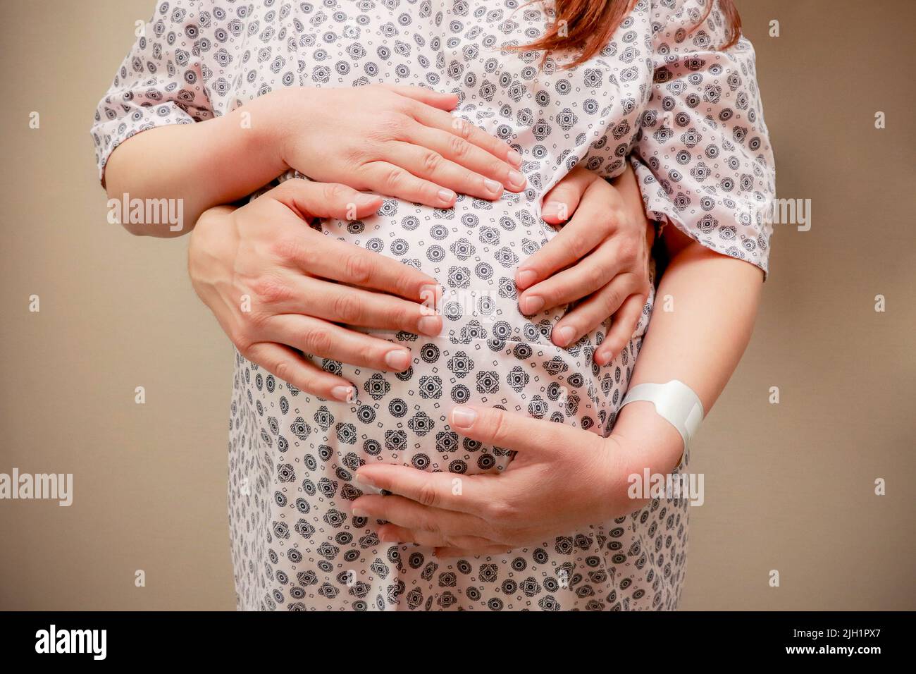 Cropped image of beautiful pregnant woman and her handsome husband ...