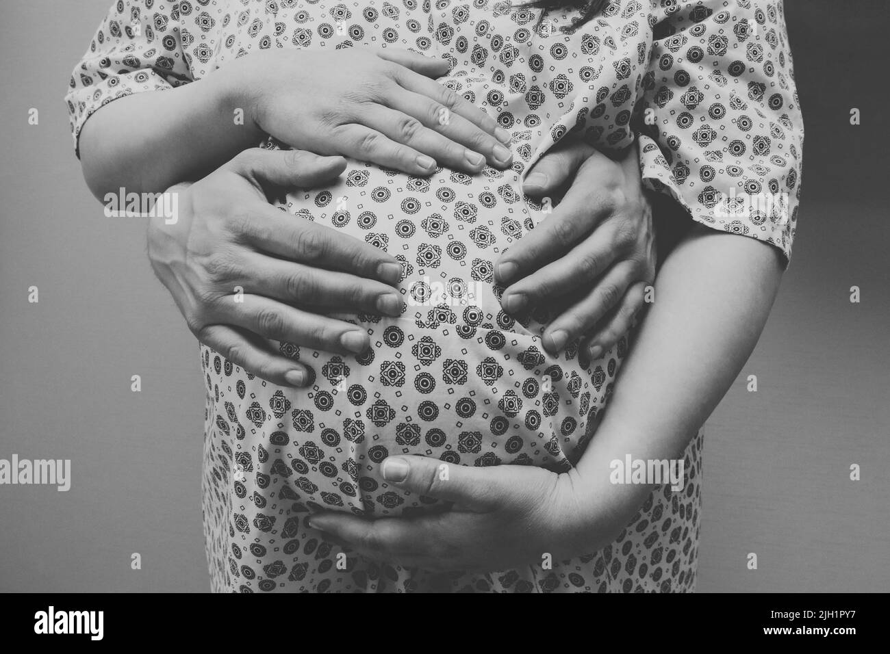 Cropped image of beautiful pregnant woman and her handsome husband ...