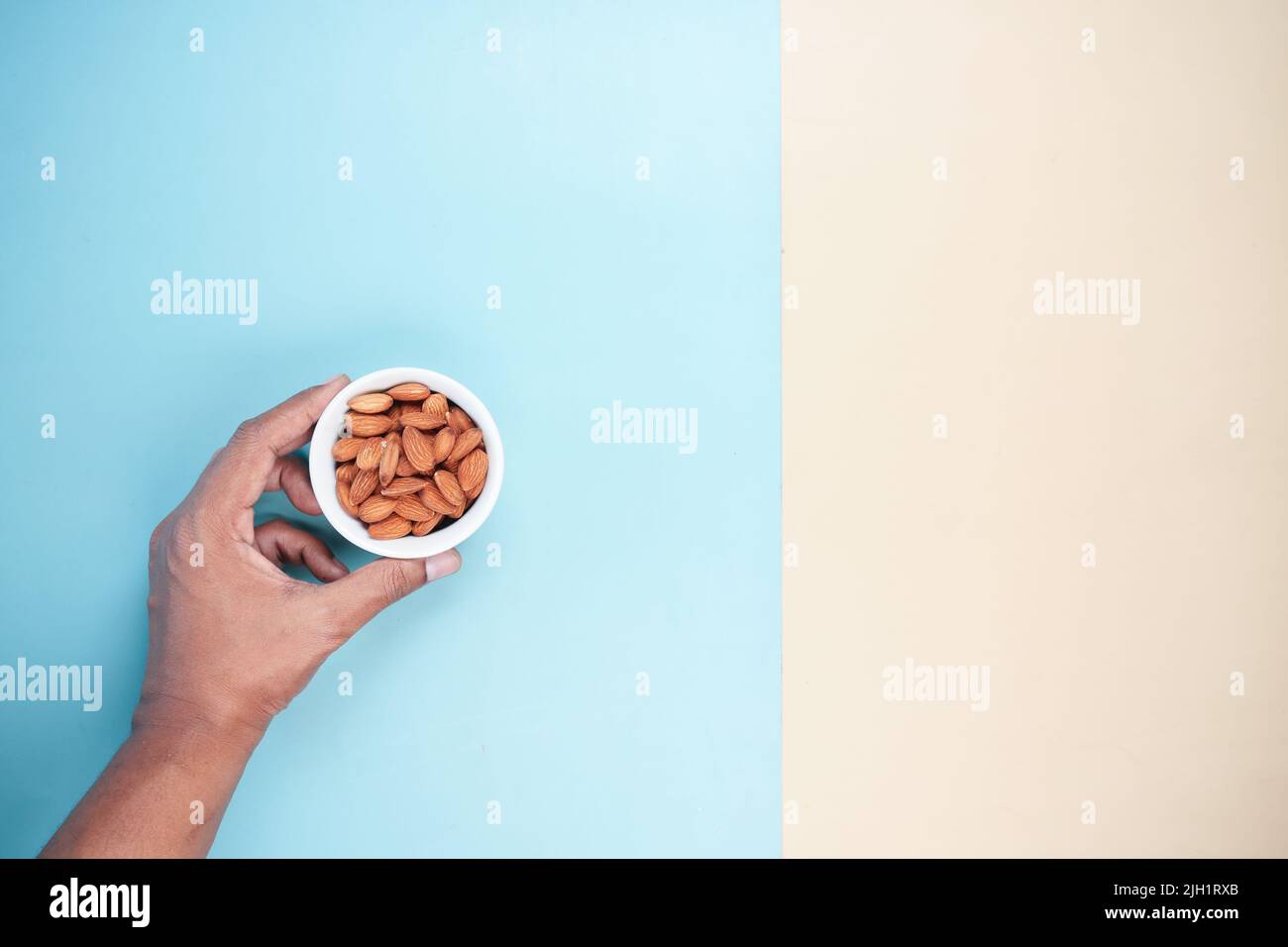 top view of almond nuts on man's hand Stock Photo - Alamy