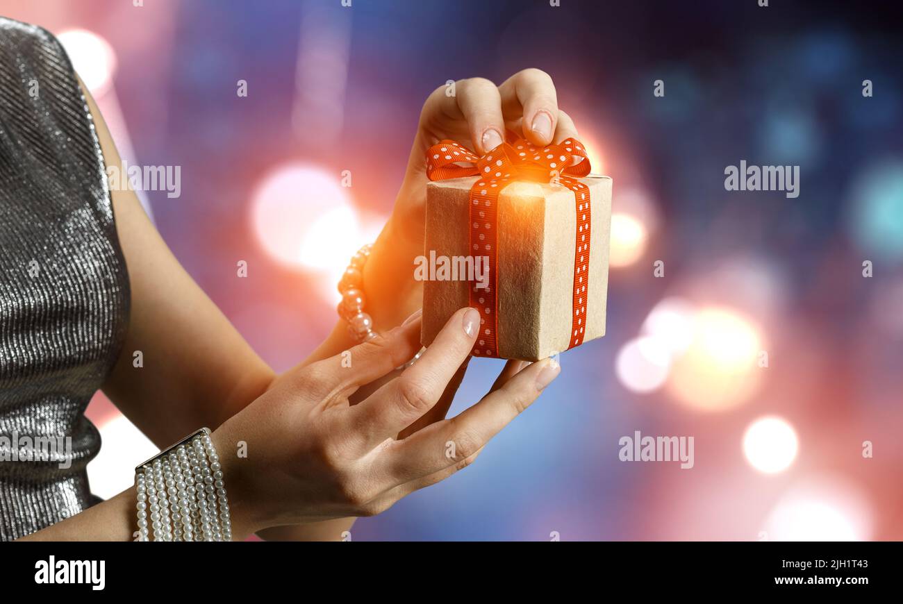 Closeup hands giving surprise gift box Stock Photo - Alamy