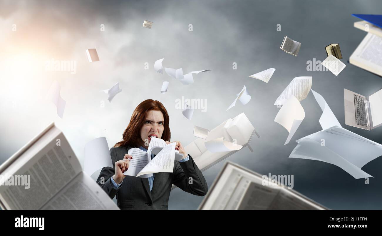 Young stressed woman ripping documents with frustrated facial ...