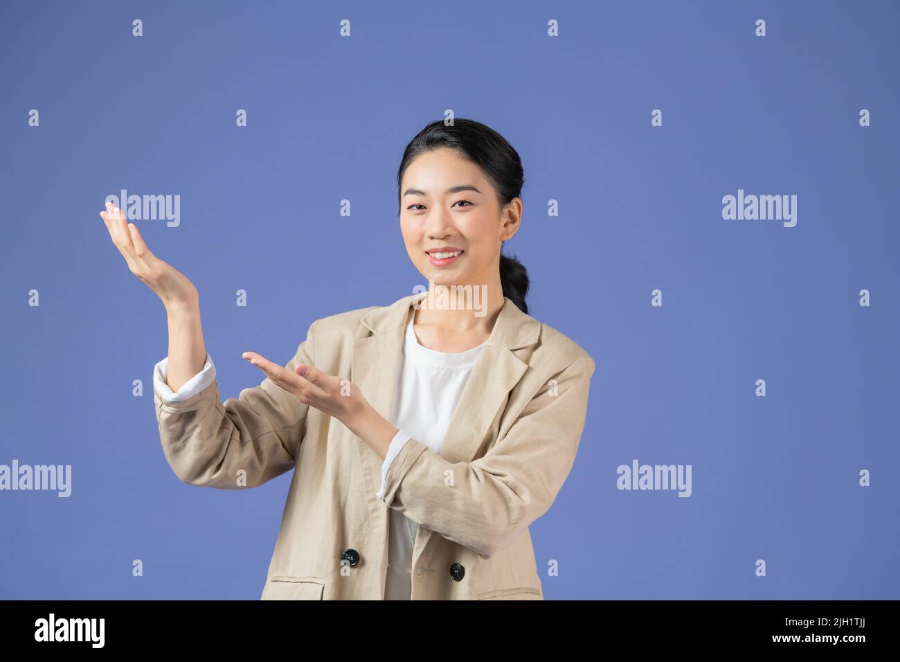 bright woman holding something invisible in hands Isolated studio Stock ...
