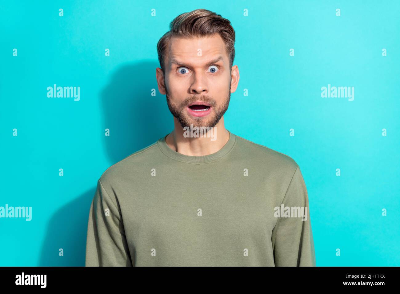 Photo of millennial blond angry guy wear khaki sweater isolated on teal ...