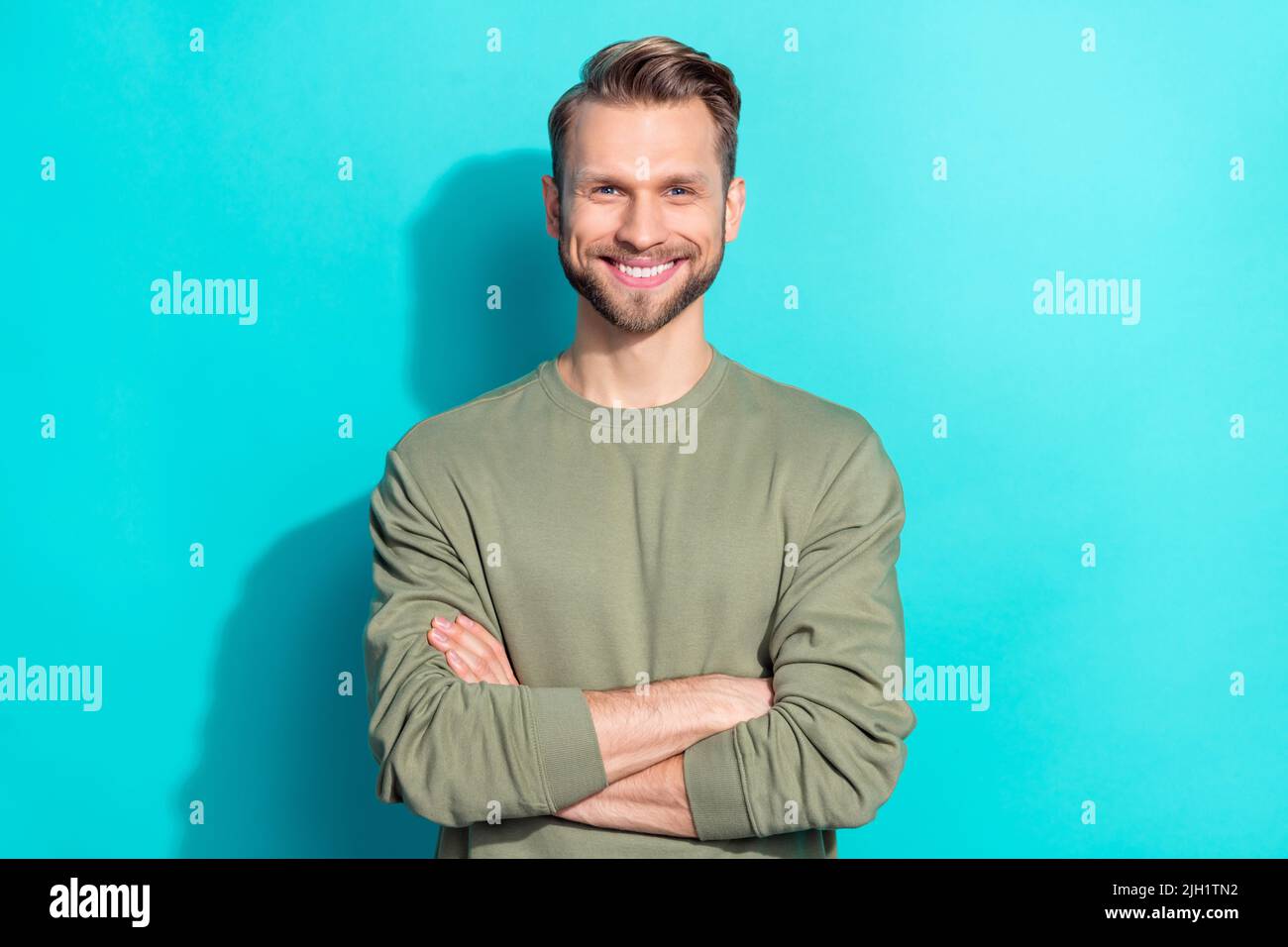 Photo of cheerful self-assured man crossed hands beaming smile wear ...