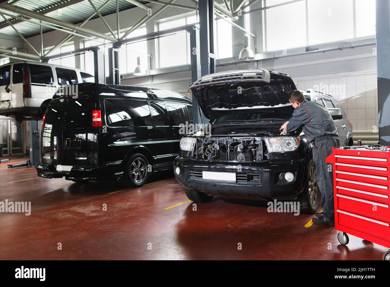Male repairer checking automobile motor hi-res stock photography and ...