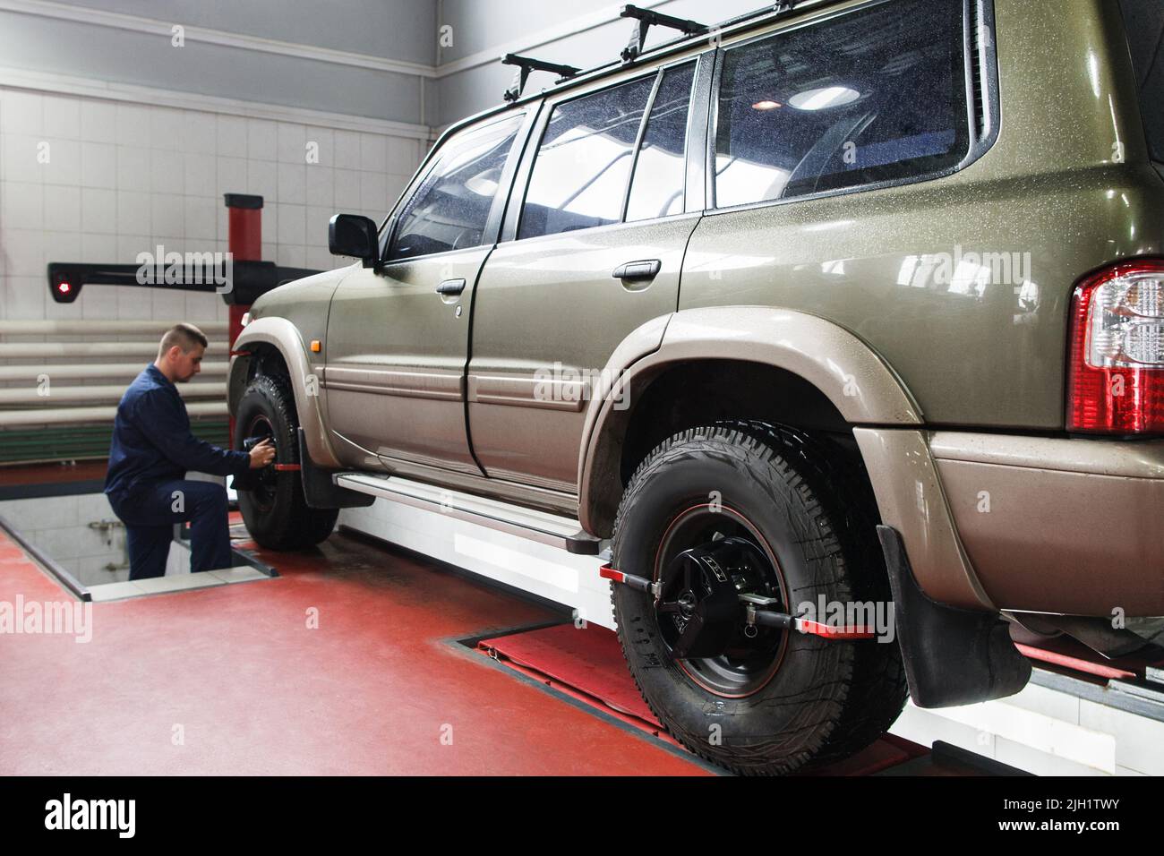 Wheel alignment for SUV in professional workshop Stock Photo - Alamy