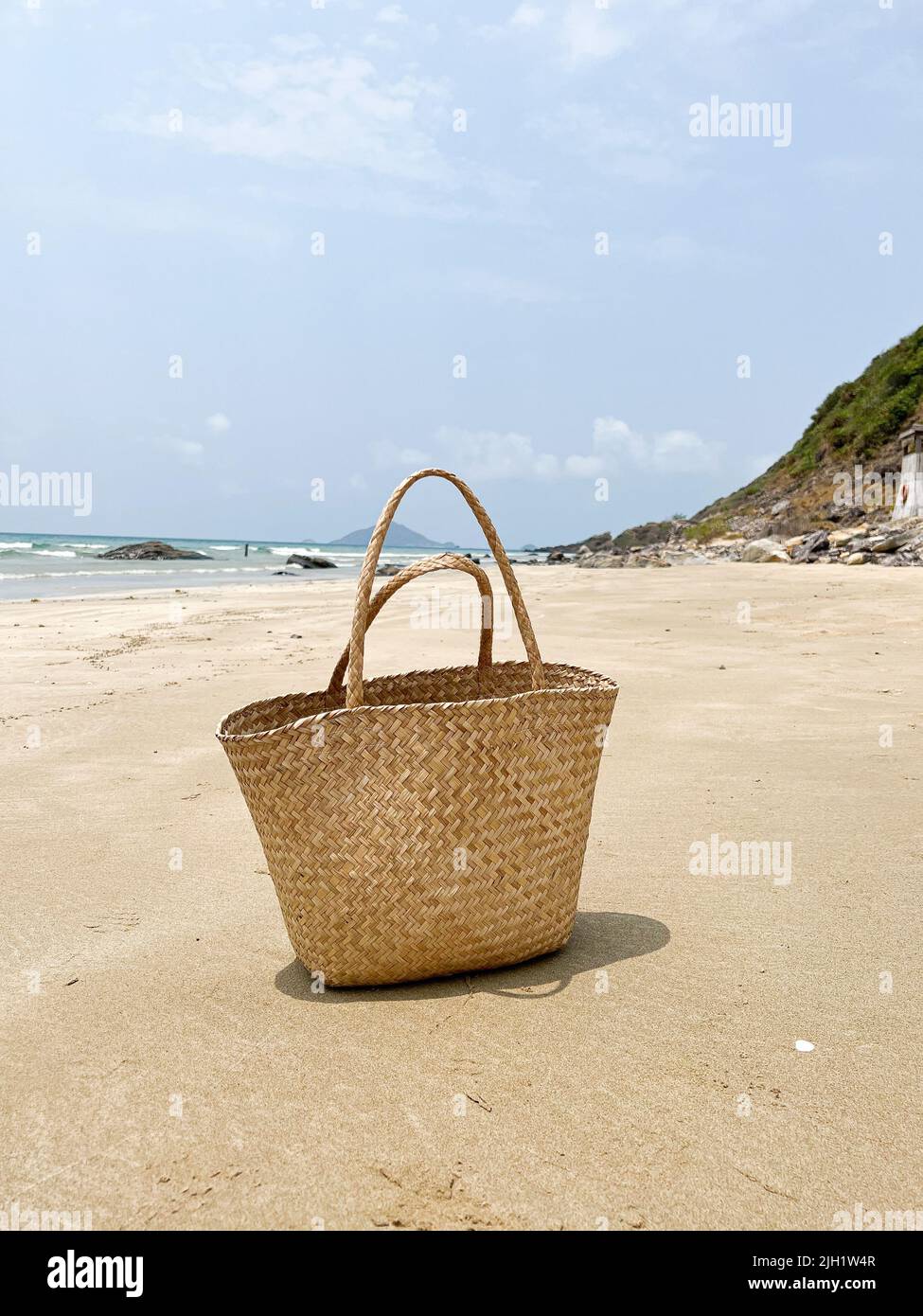 Photo of straw beach bag on exotic sand beach Stock Photo - Alamy