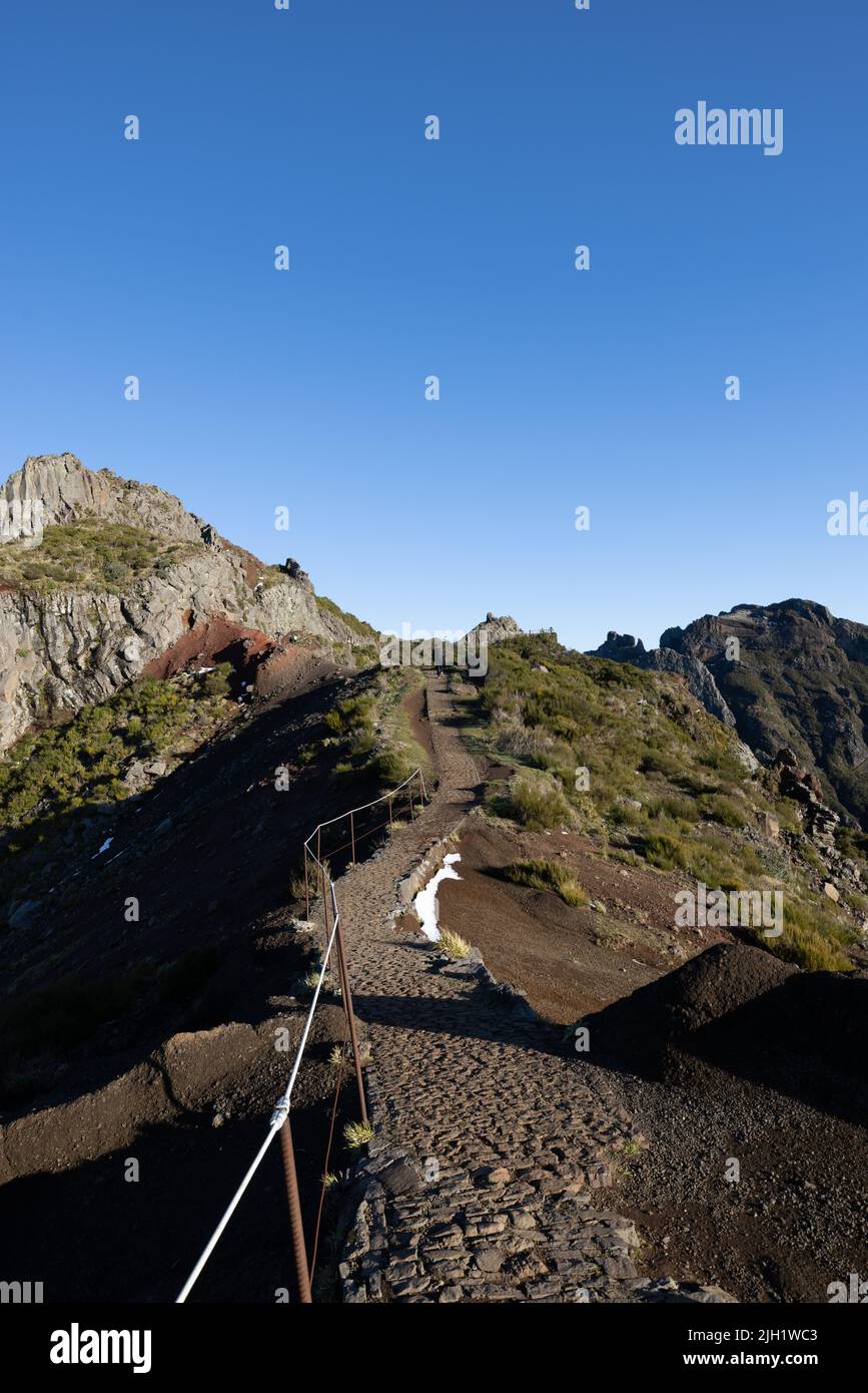 the vertical view of the mountain hiking pathway against the blue sky ...
