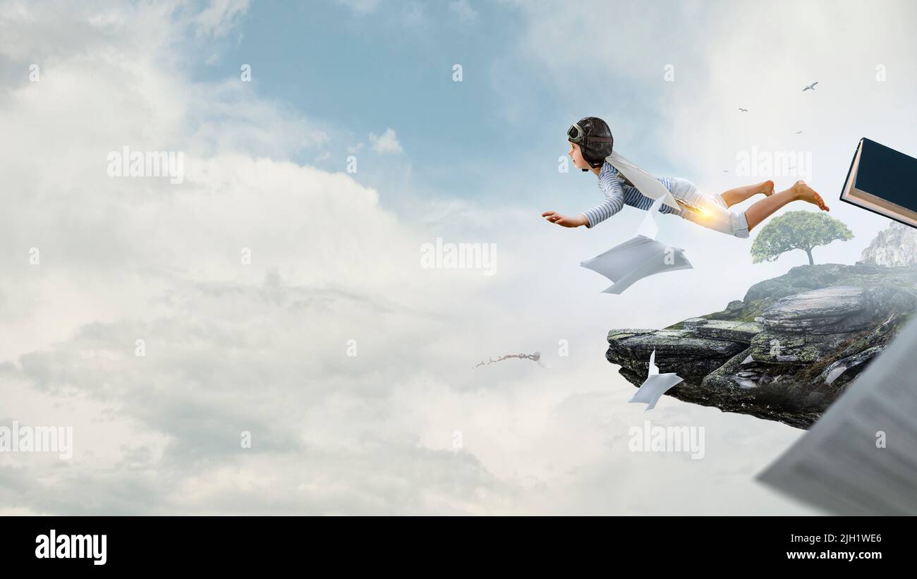 World of books concept with flying boy Stock Photo - Alamy