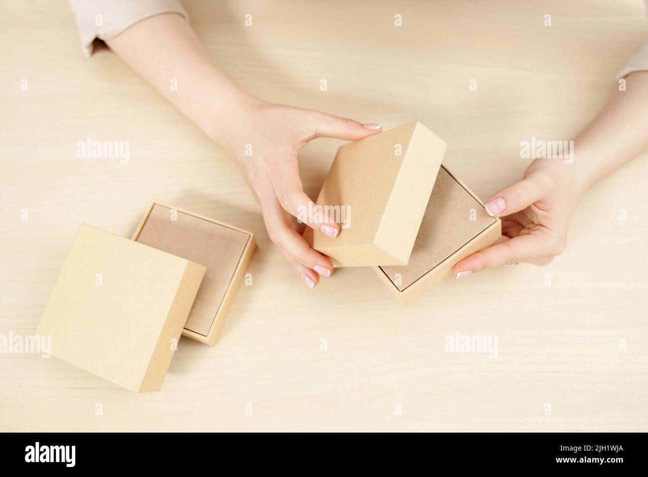 Female hands opening carton box, flat lay Stock Photo - Alamy