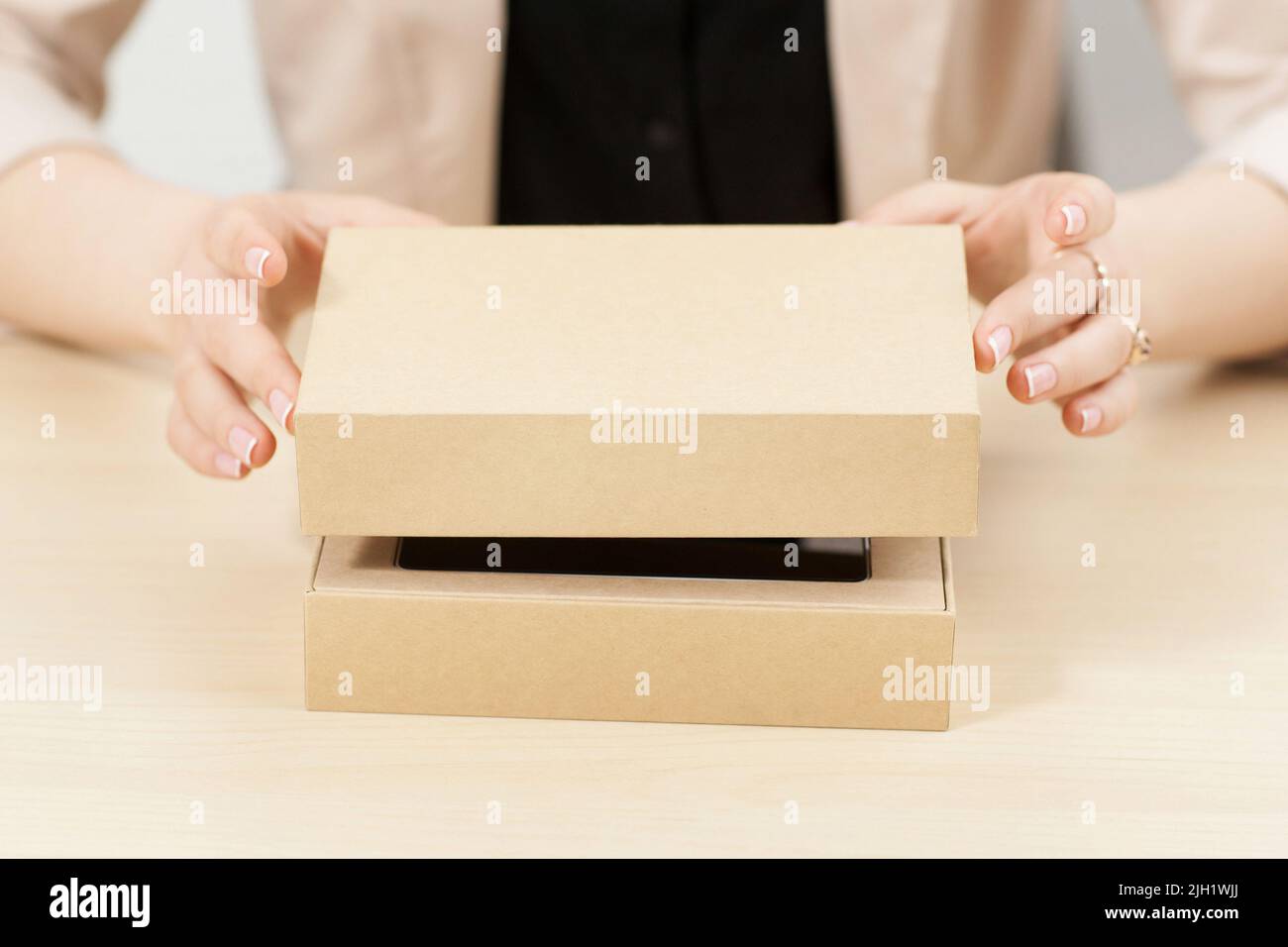 Woman opening box with new parcel, close-up Stock Photo - Alamy