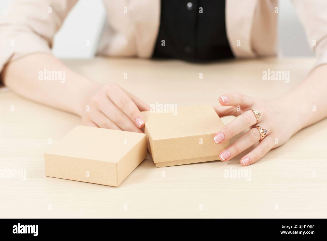 Woman holding two carton boxes on table Stock Photo - Alamy