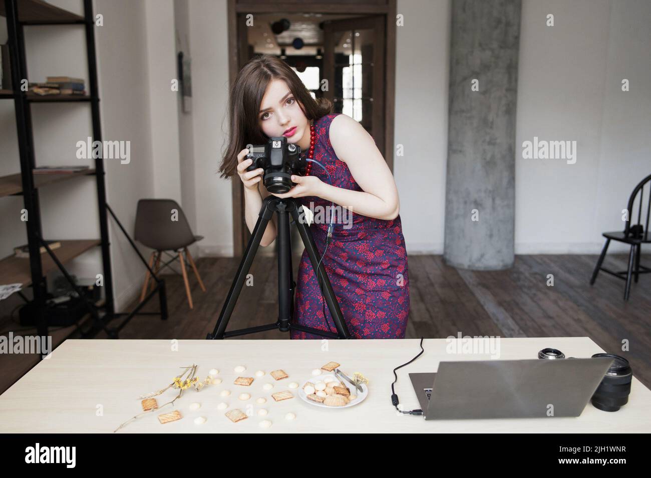 Female photographer working with sweets at studio Stock Photo - Alamy
