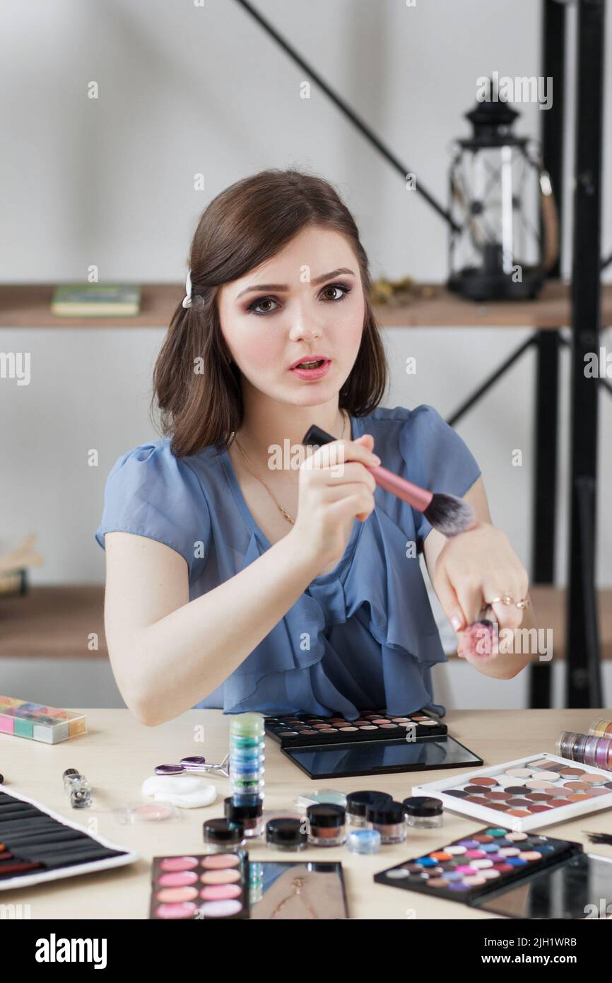 Proffesional makeup artist testing brush softness Stock Photo - Alamy