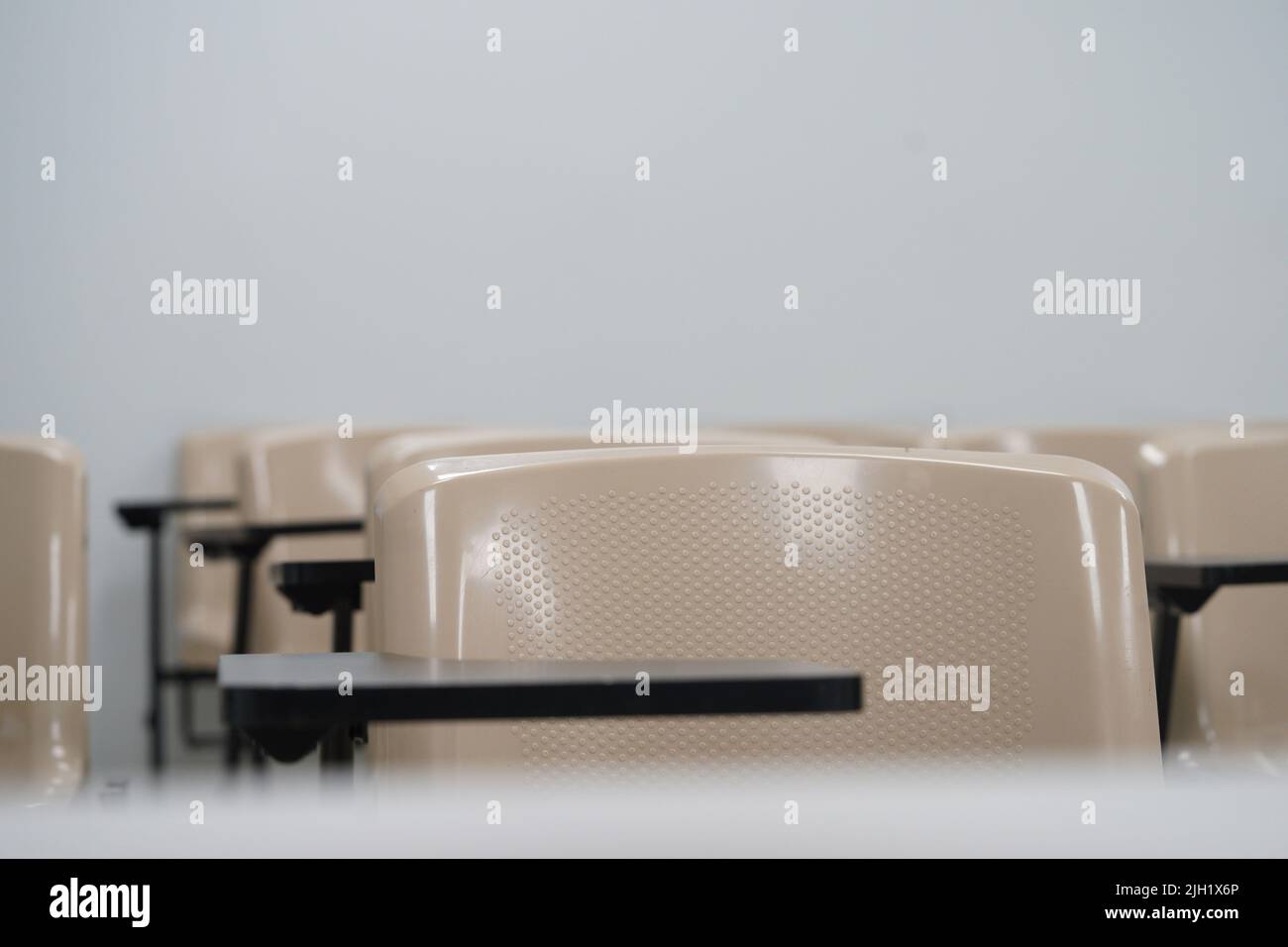 Empty class at university or school with chairs and side table and ...