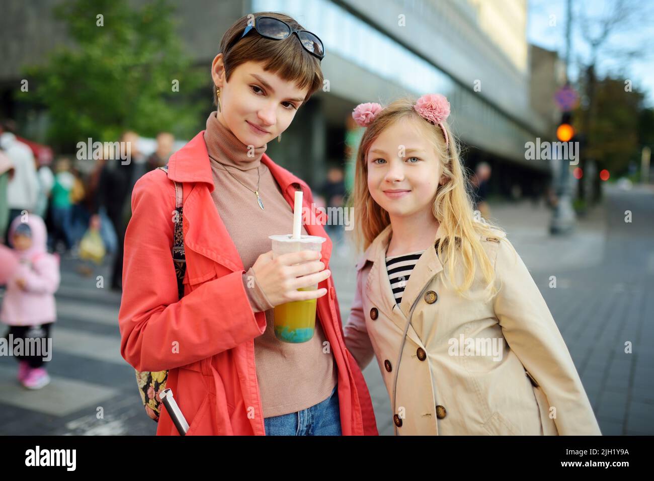 Two cute young sisters having fun together on beautiful autumn day ...