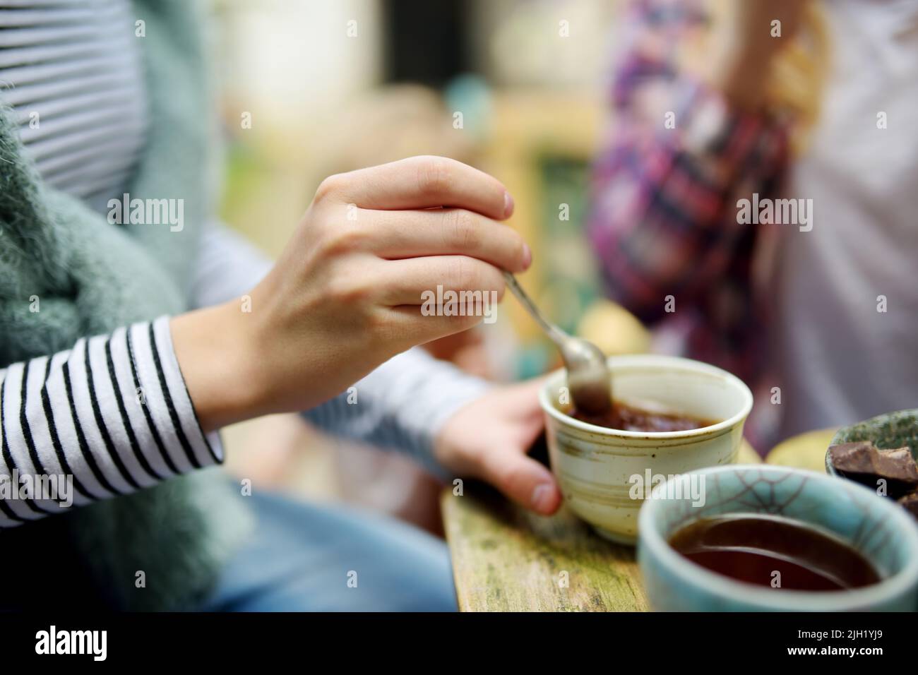 Woman's hand stirring Chinese green tea in old ceramic cup Stock Photo ...